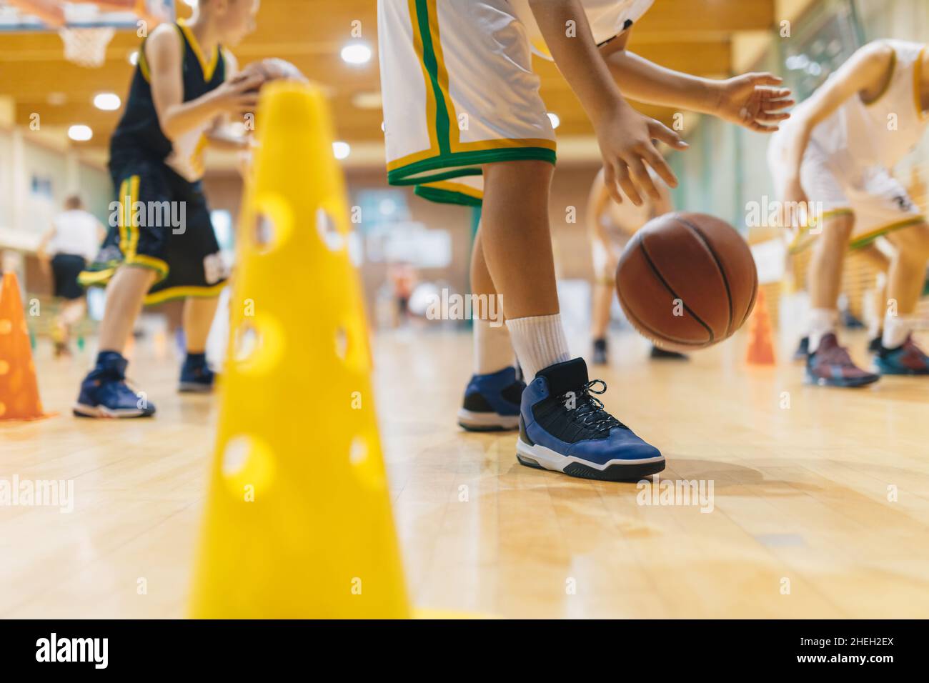 School of basketball for kids. Young basketball players bounce balls on ...