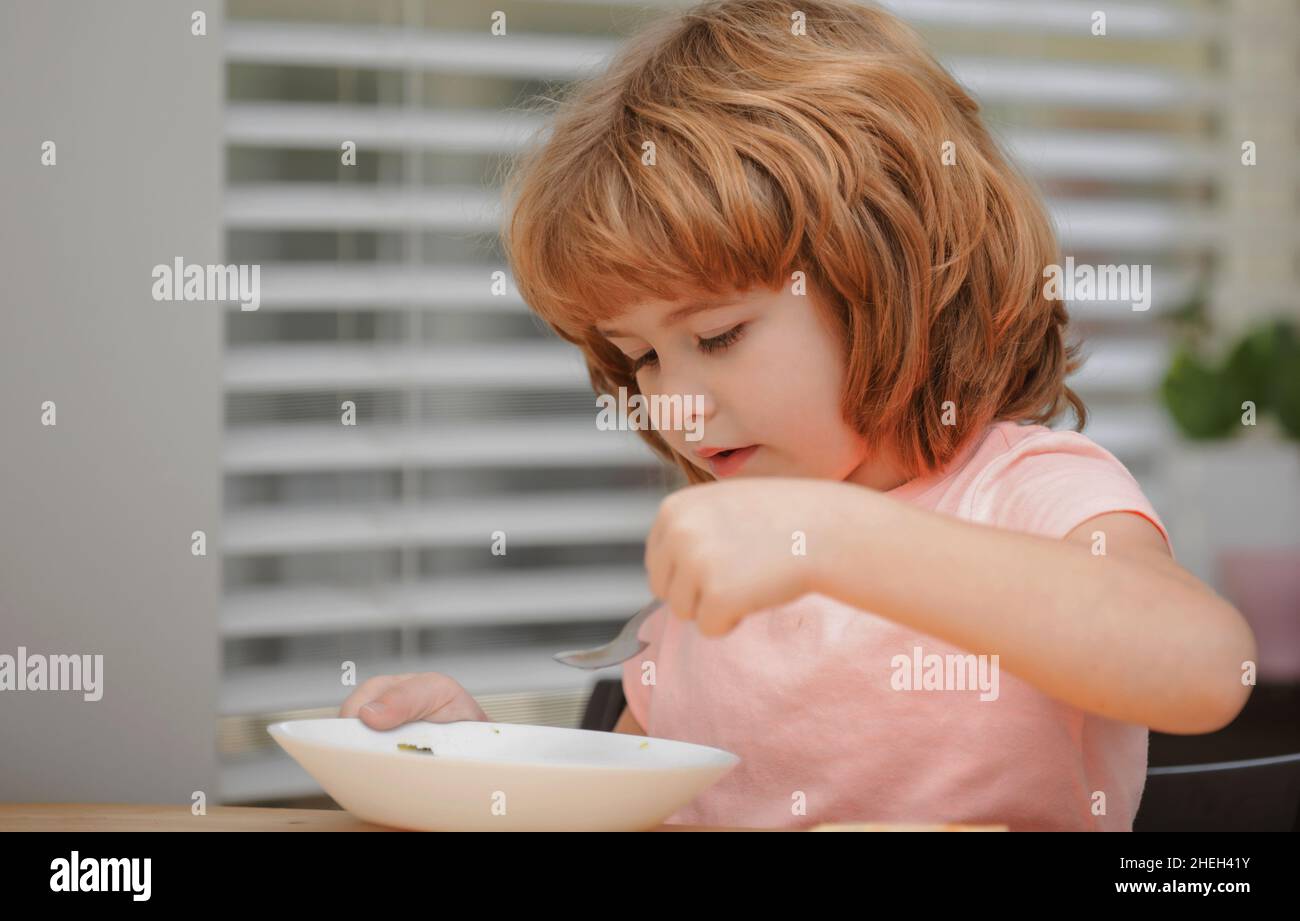 Funny kid with plate of soup. Child dinner Stock Photo - Alamy