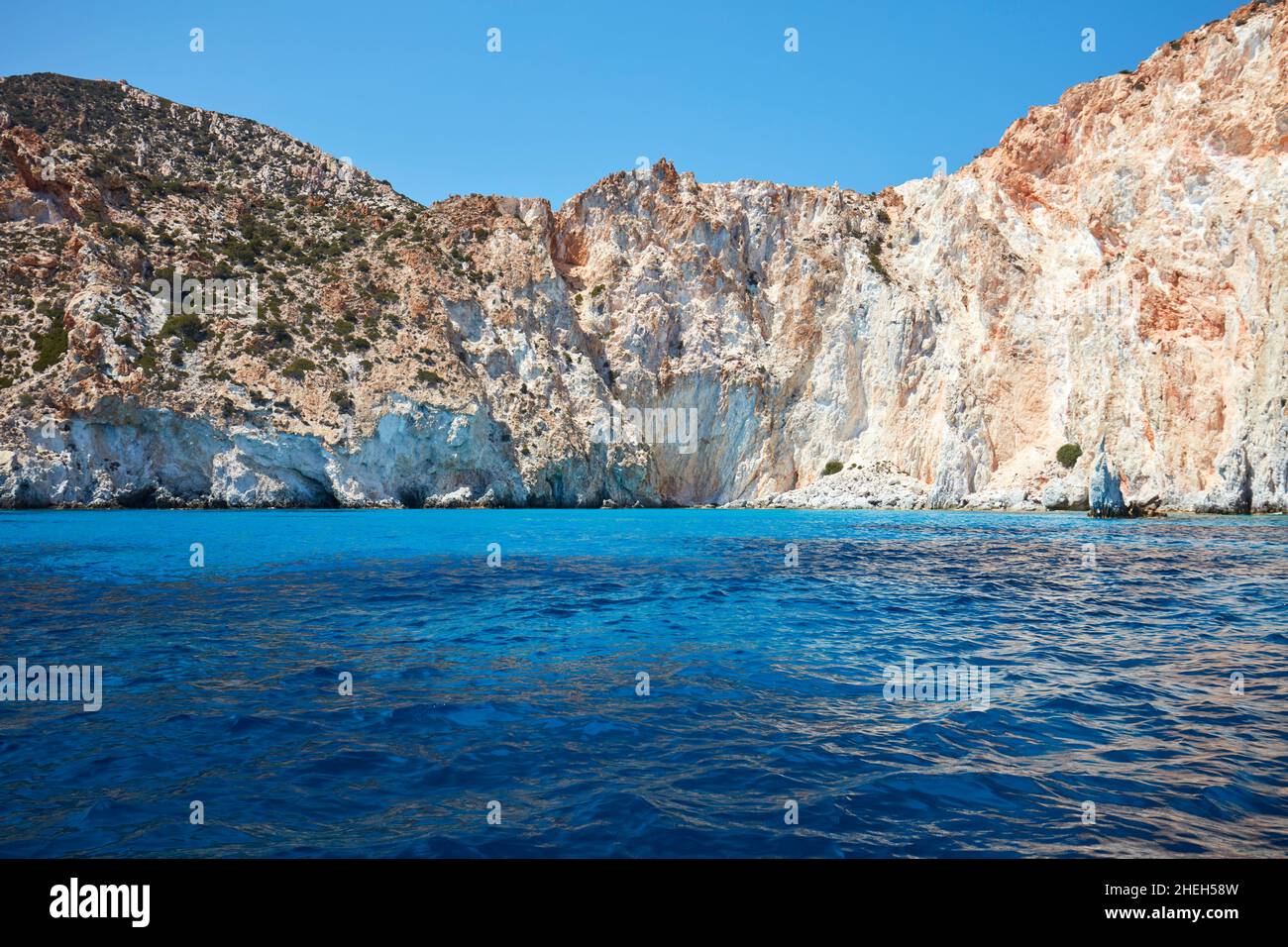 Bright blue water and cliffs of Polyaigos Stock Photo - Alamy
