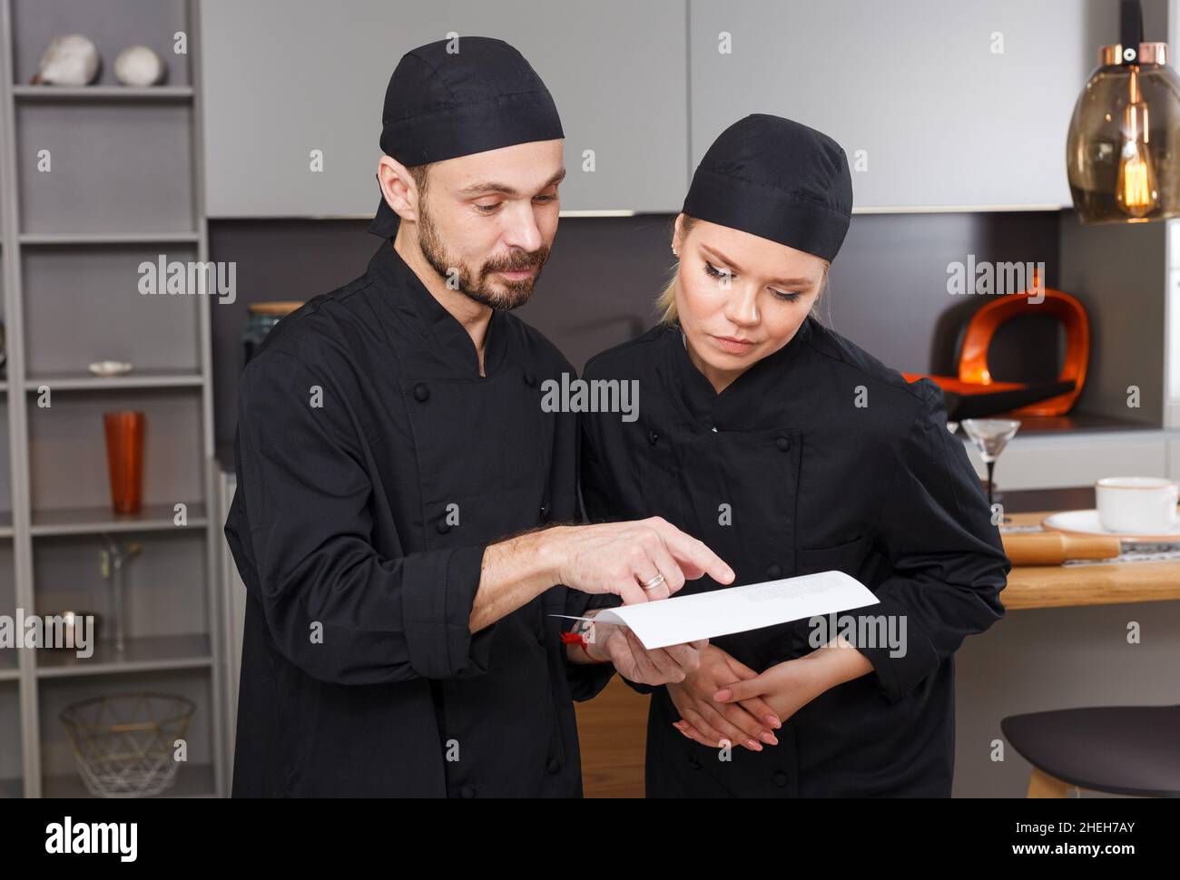 Chefs discussing menu Stock Photo - Alamy