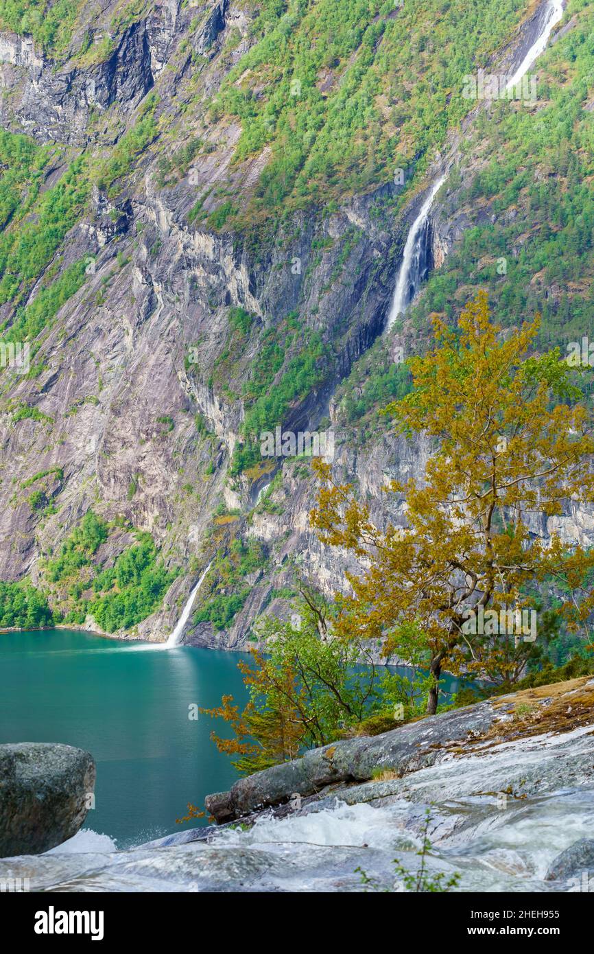 VALLDAL, NORWAY - 2020 JUNE 06. Waterfall running down the mountain and ...