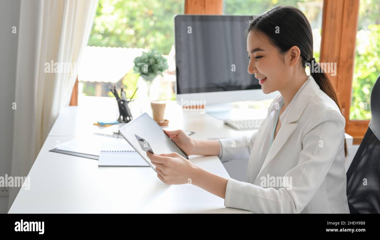 Side view, Successful asian businesswoman using digital touchpad tablet ...