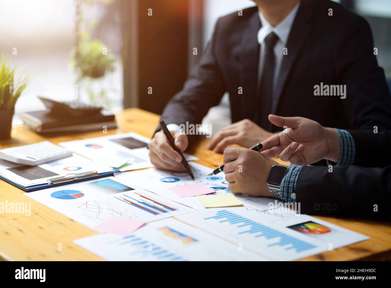 Cropped shot of a two professional male banker or financial investment ...