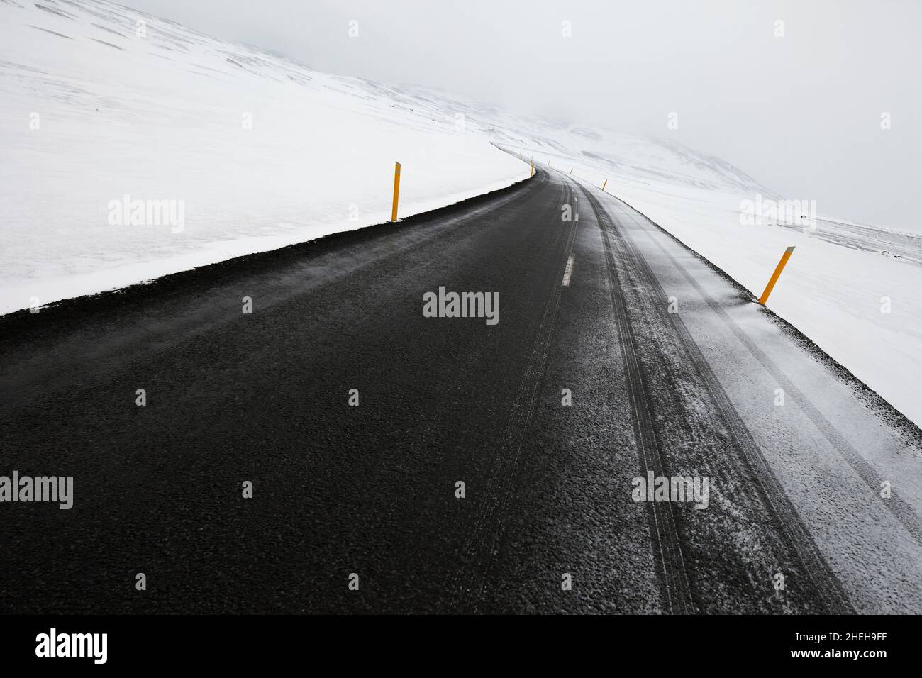Country road in winter partially covered with snow Stock Photo - Alamy