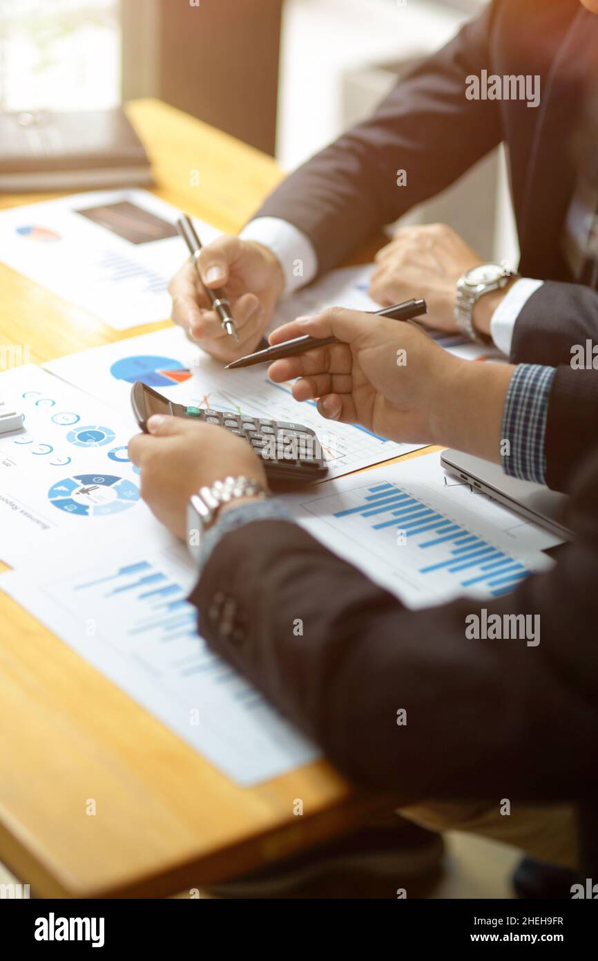 A group of financial analysts analysing and calculating project budget ...