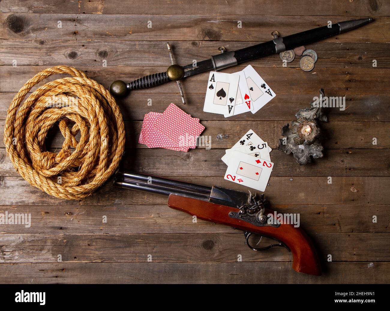 Playing cards in a pirate style, among the weapons spread out on a ...