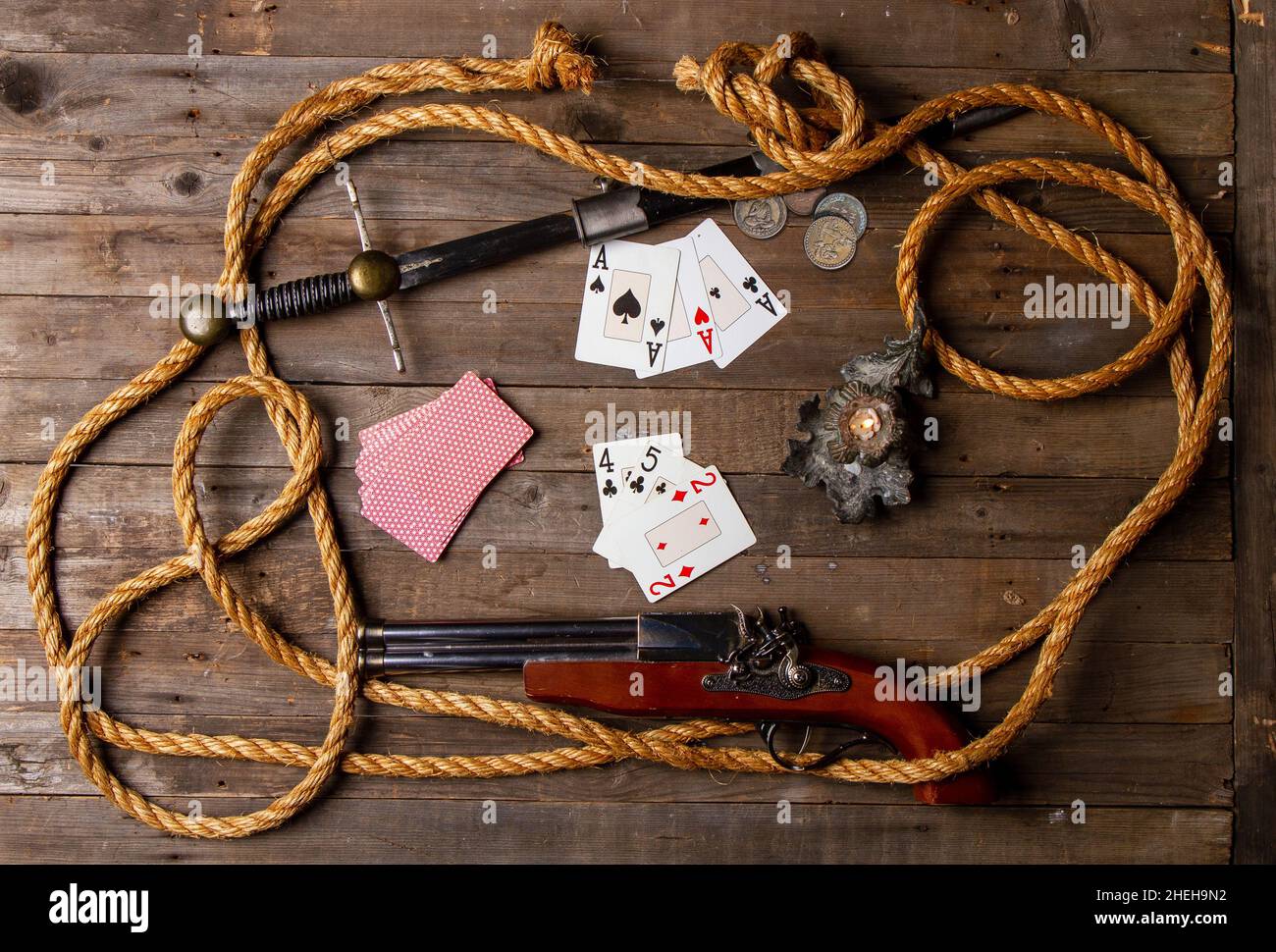 Playing cards in a pirate style, among the weapons spread out on a ...