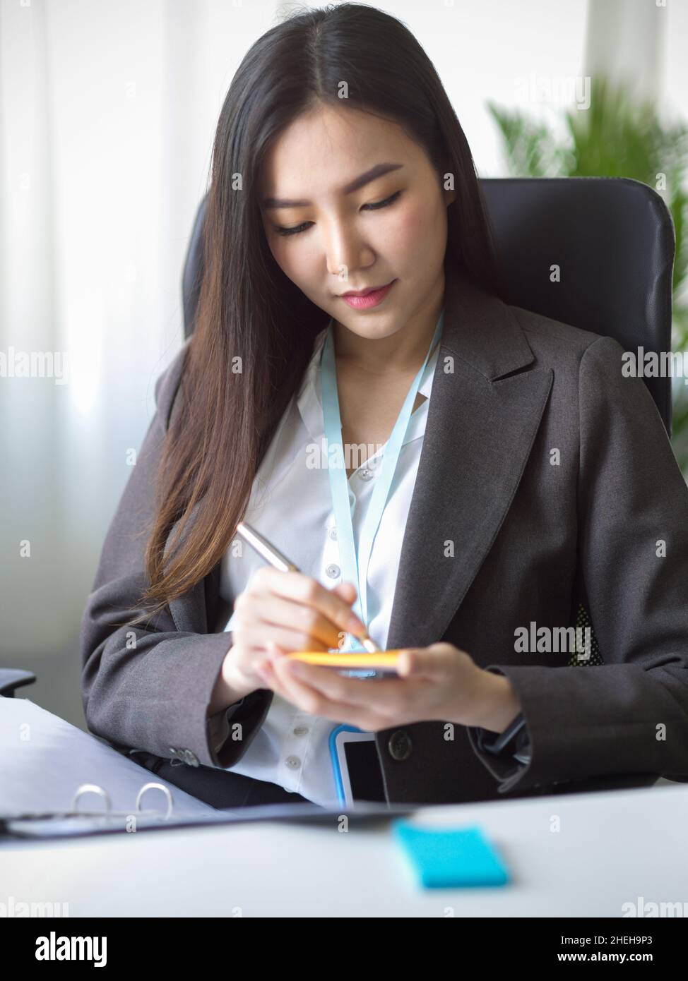 Portrait of a beautiful businesswoman or female manager taking a notes ...