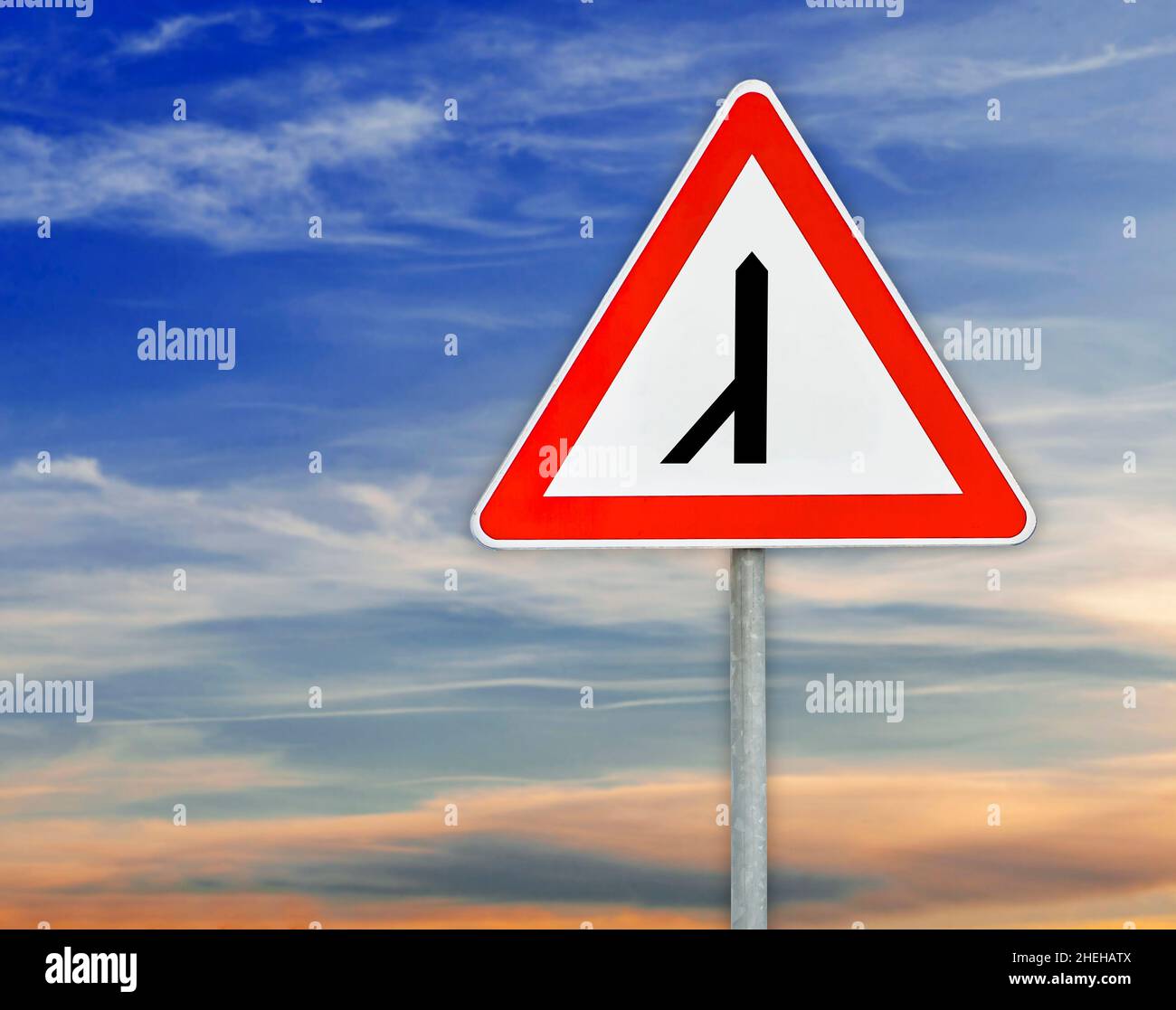 Triangle road sign with direction Stock Photo - Alamy