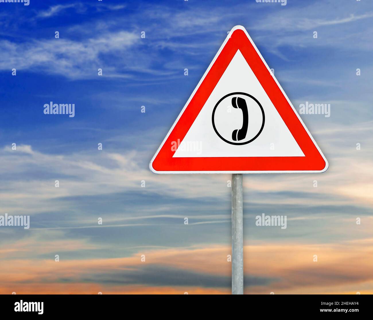 Triangle road sign phone area on rod Stock Photo - Alamy