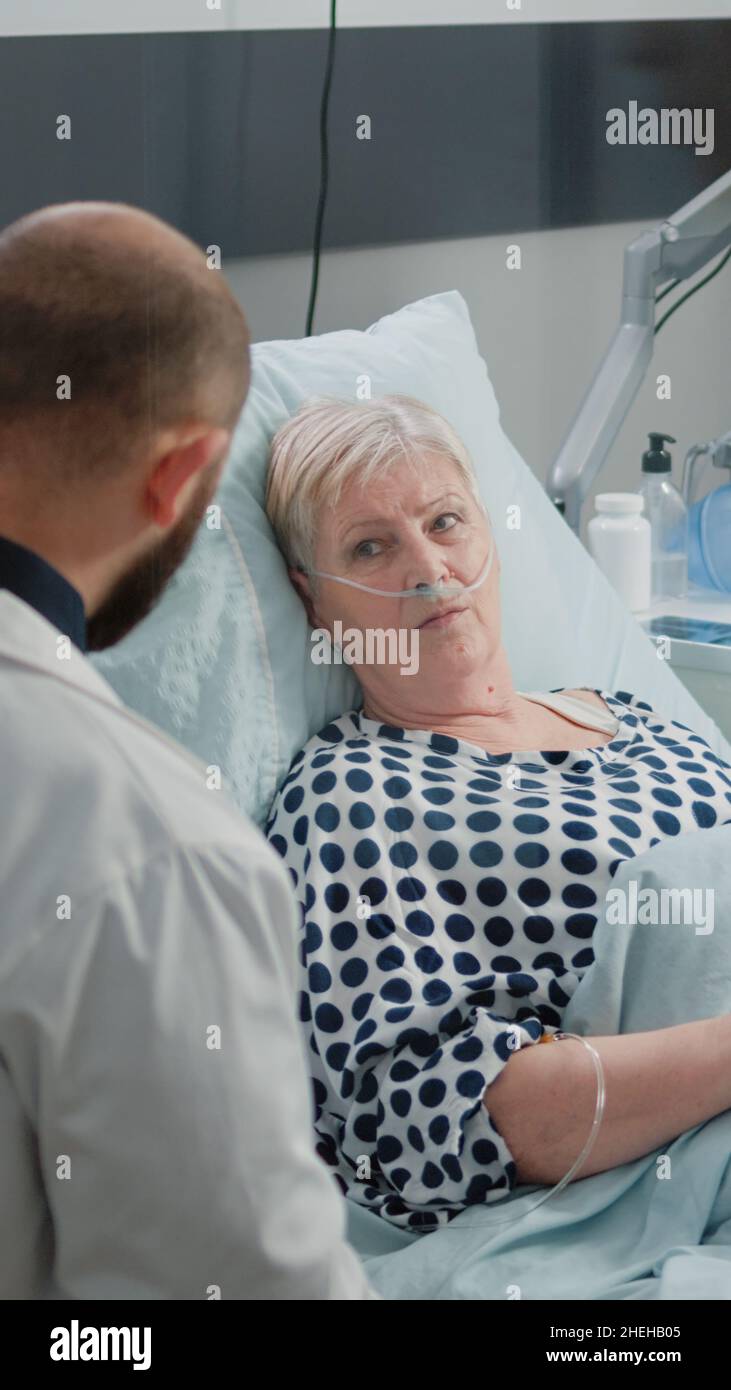 Medic holding bottle of pills for prescription treatment to cure aged ...