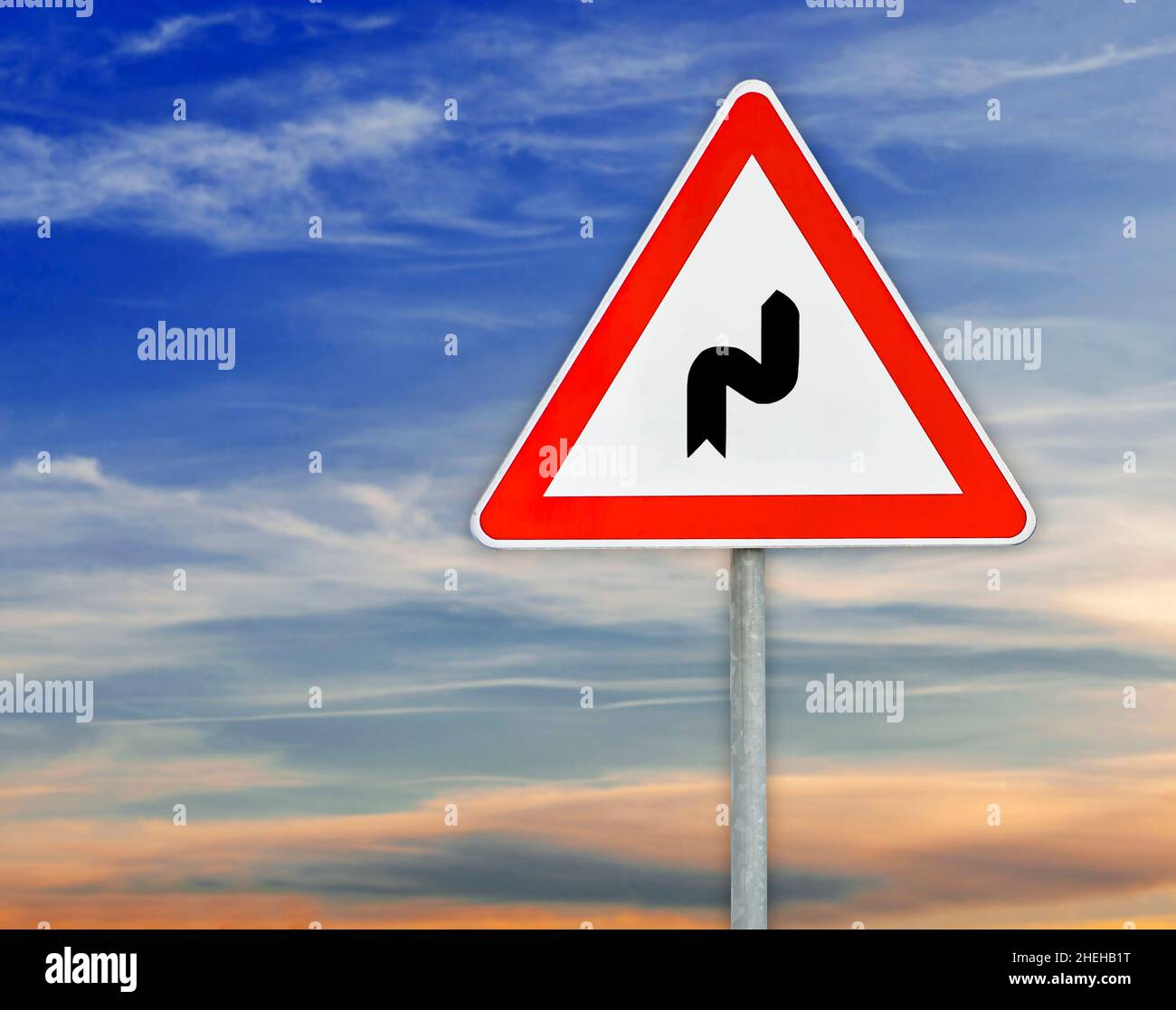 Triangle road sign with direction Stock Photo - Alamy