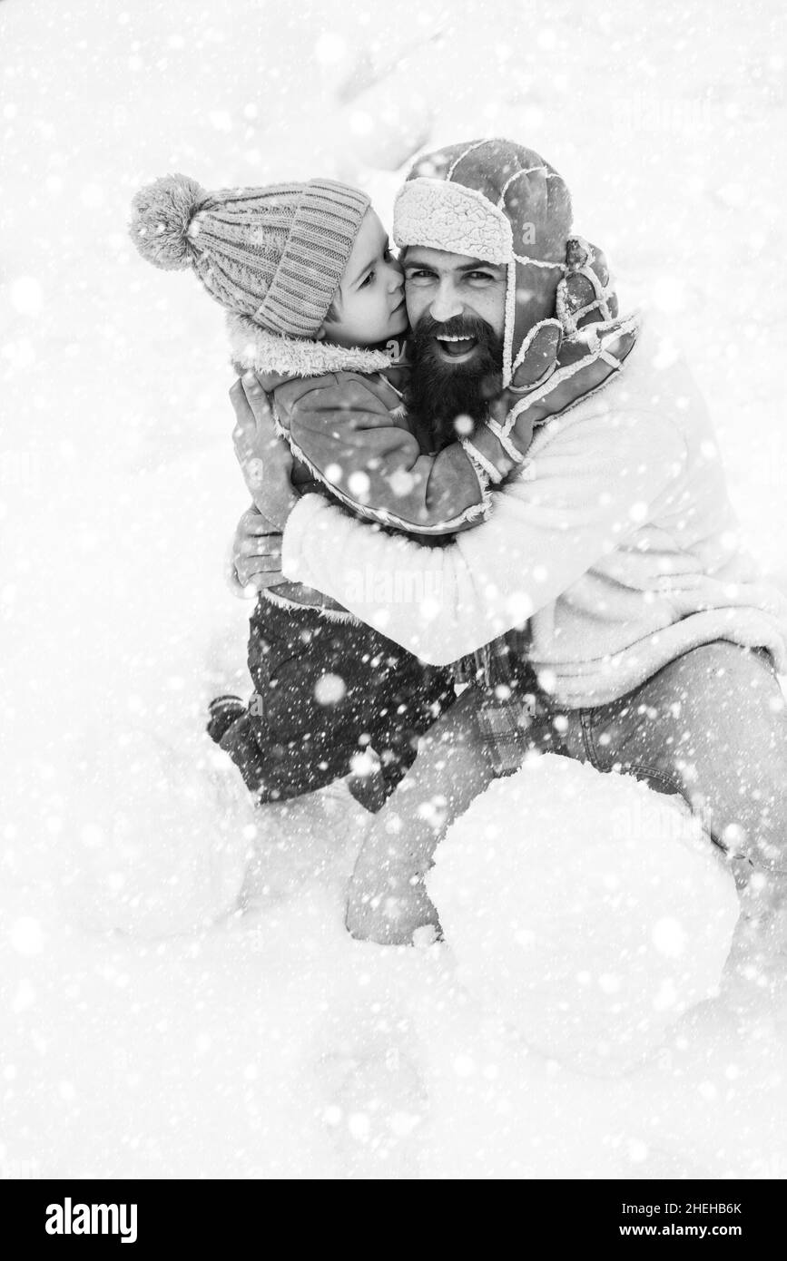 Children kissing smiling father Black and White Stock Photos & Images ...