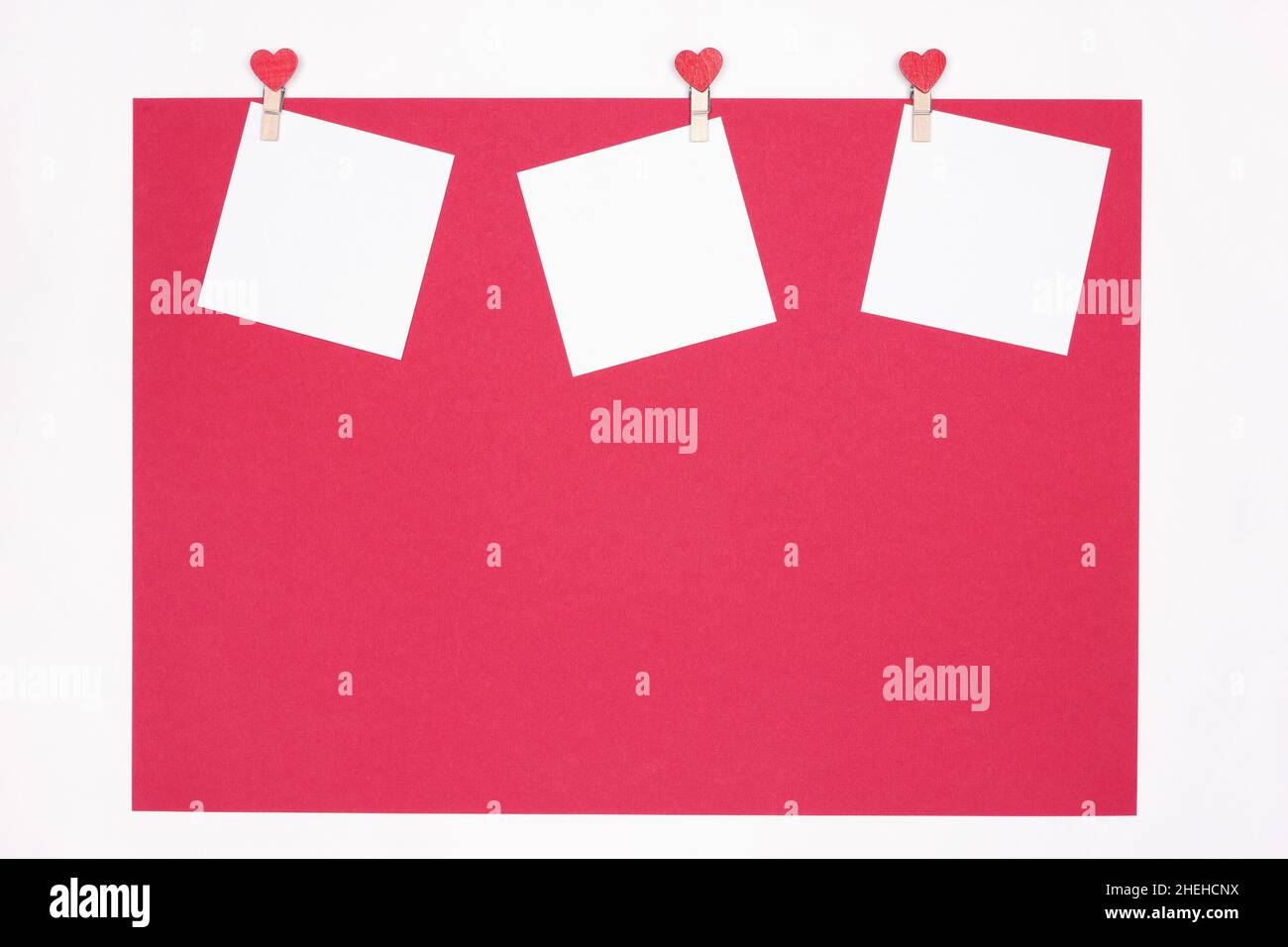 Blank white note paper sheets with heart shaped pins. Copy space ...