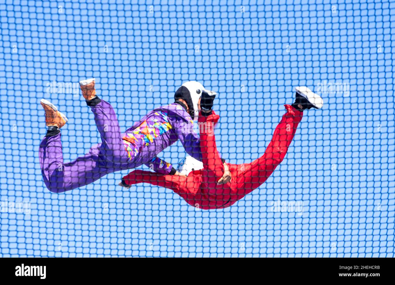 A instructor is training a student in wind tunnel. Outdoor skydiving ...