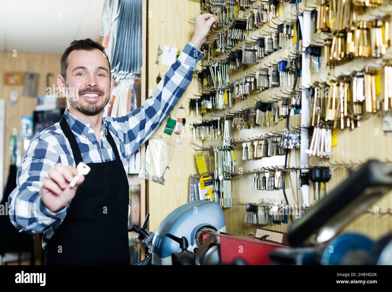 Worker demonstrating newly shaped key Stock Photo - Alamy