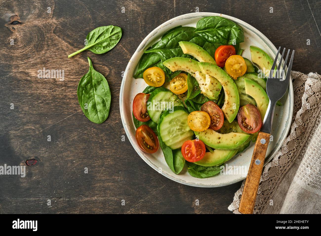Avocado, red, yellow, black cherry tomato, spinach and cucumber fresh ...