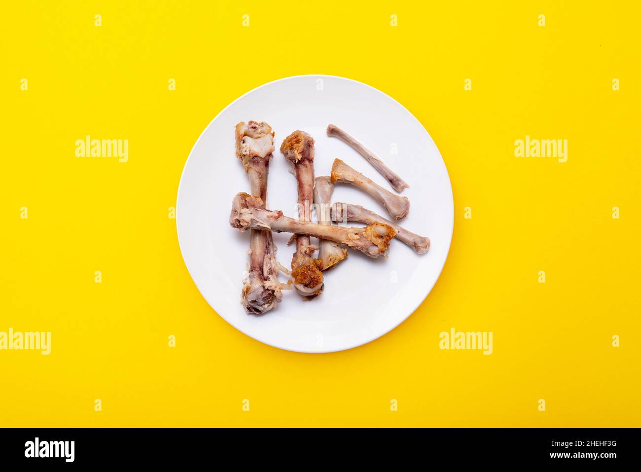 Messy food leftover, chicken bones as fast food on the ceramic white ...