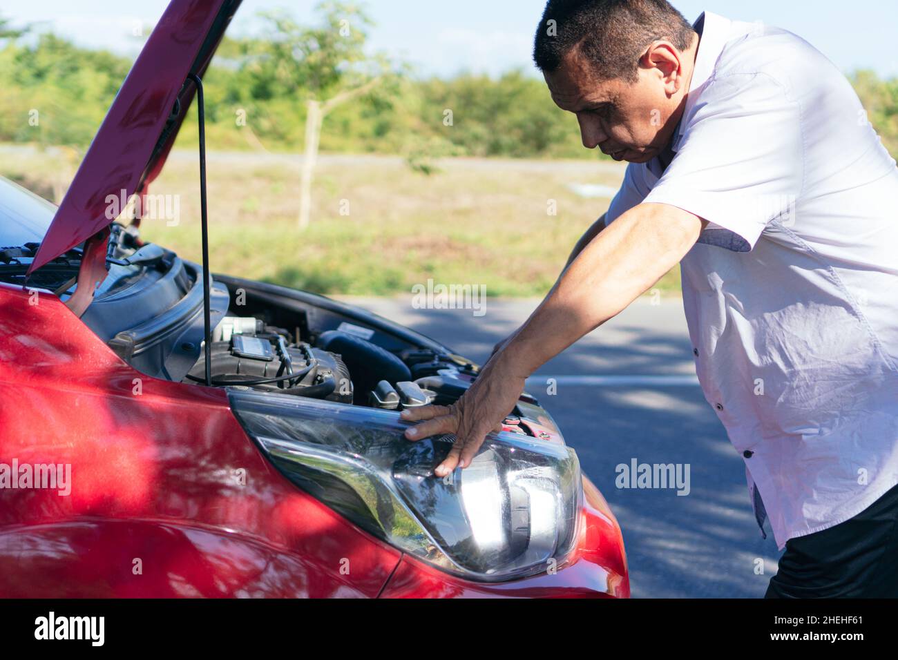 Man repairing car on road hi-res stock photography and images - Alamy