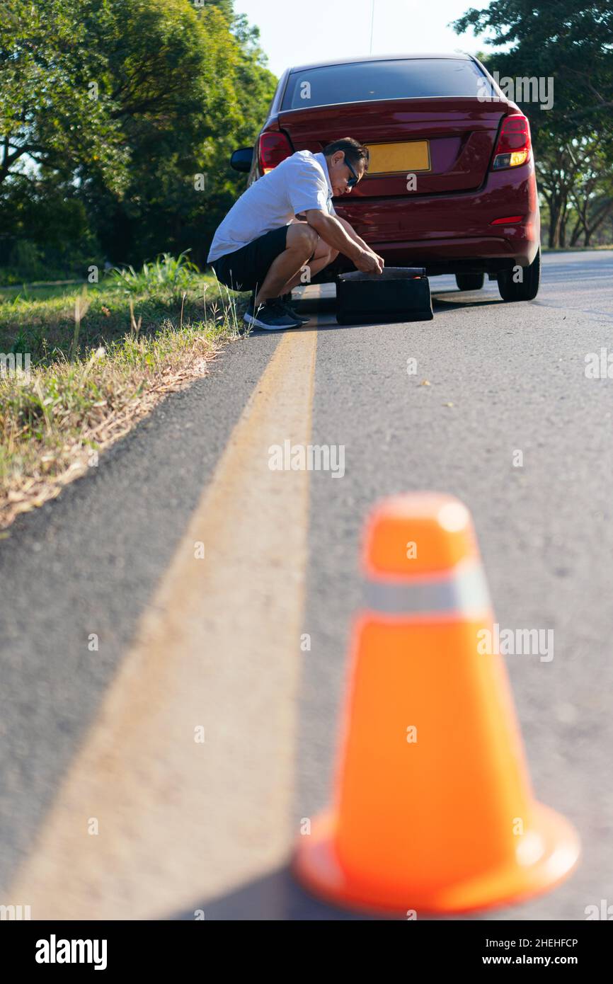 Emergency stop sign and man with broken down car on the highway Stock ...