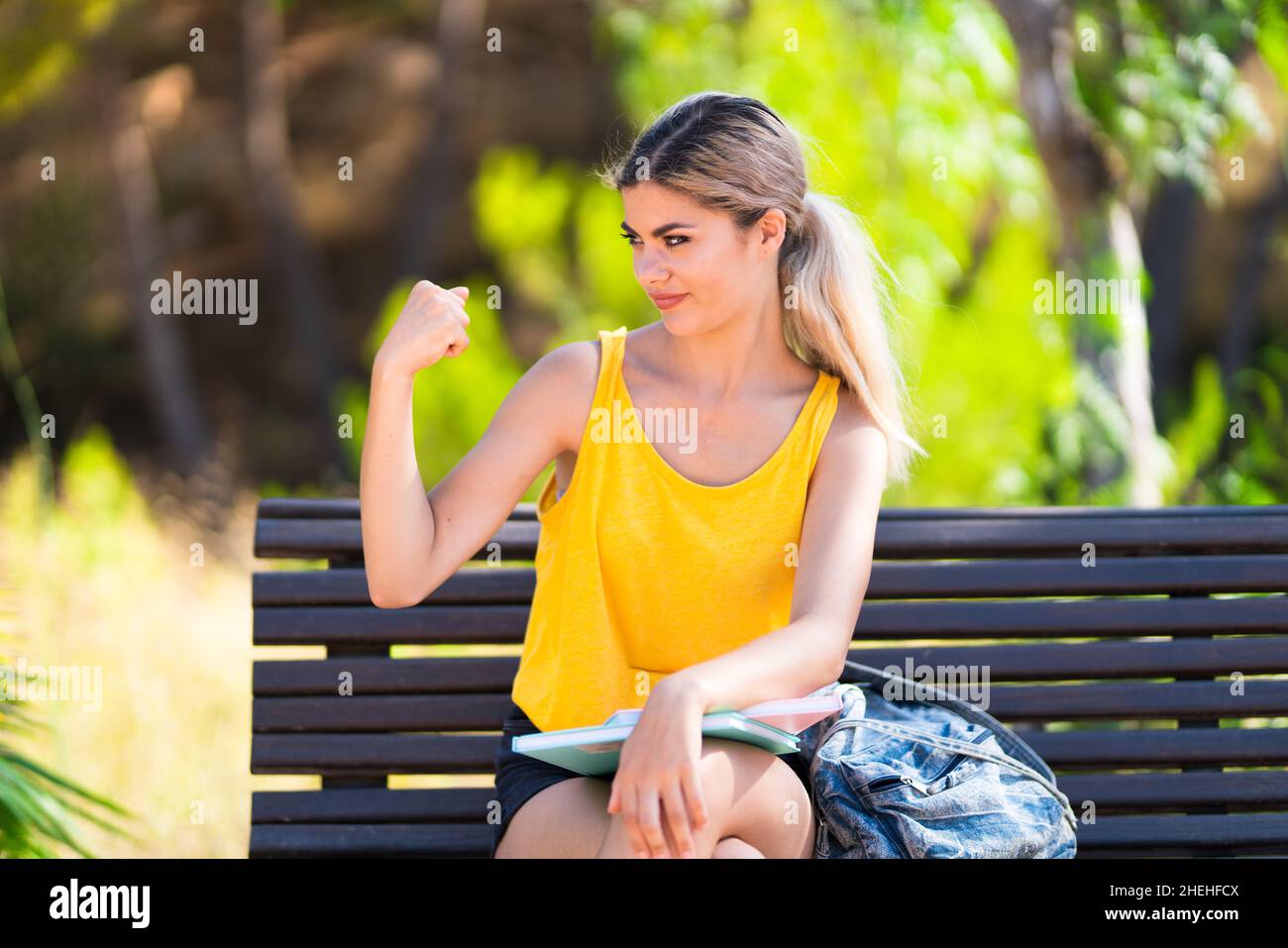 Teenager student girl at outdoors doing strong gesture Stock Photo - Alamy