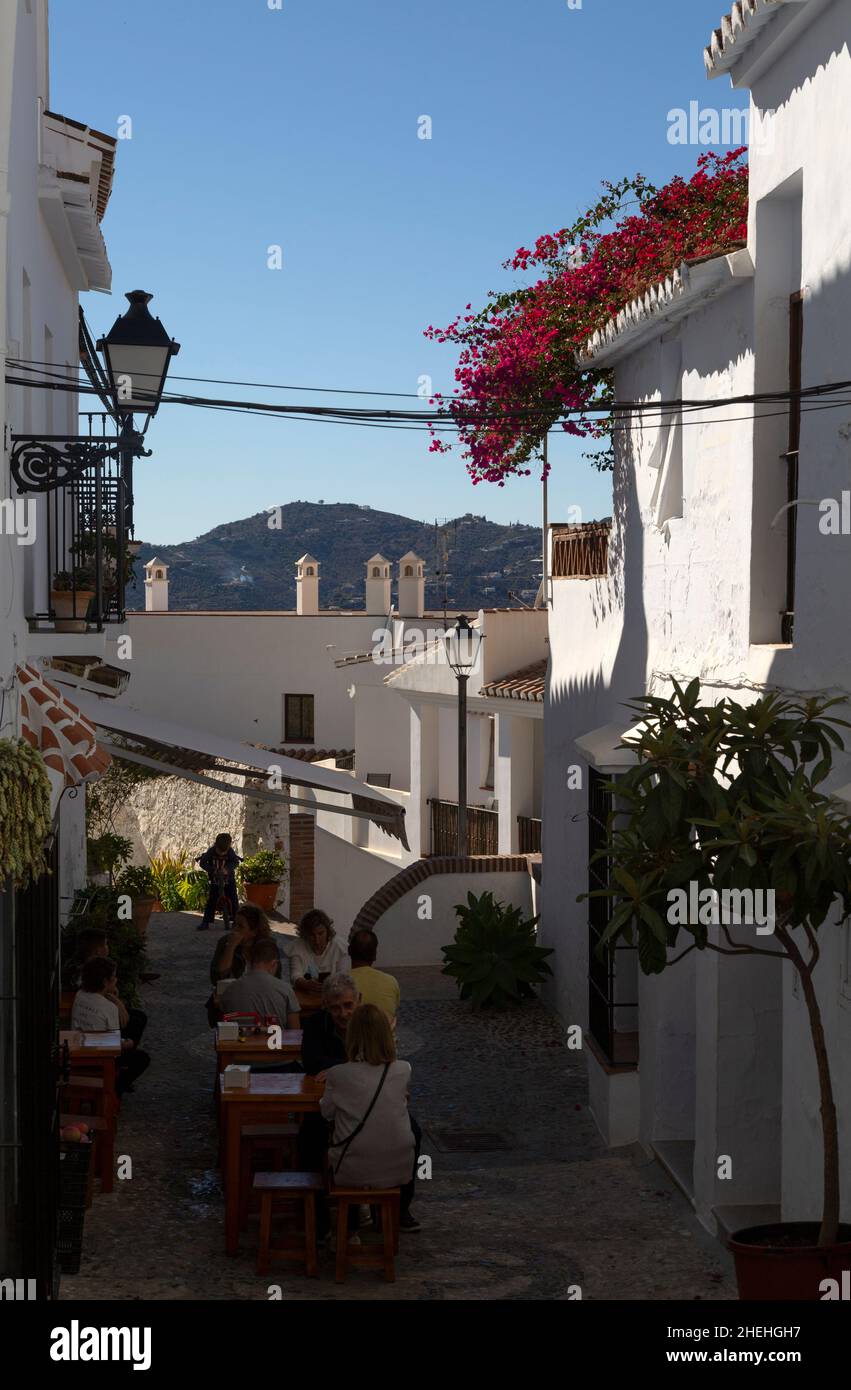 Traditional pueblo blanco whitewashed houses, street cafe in shade ...
