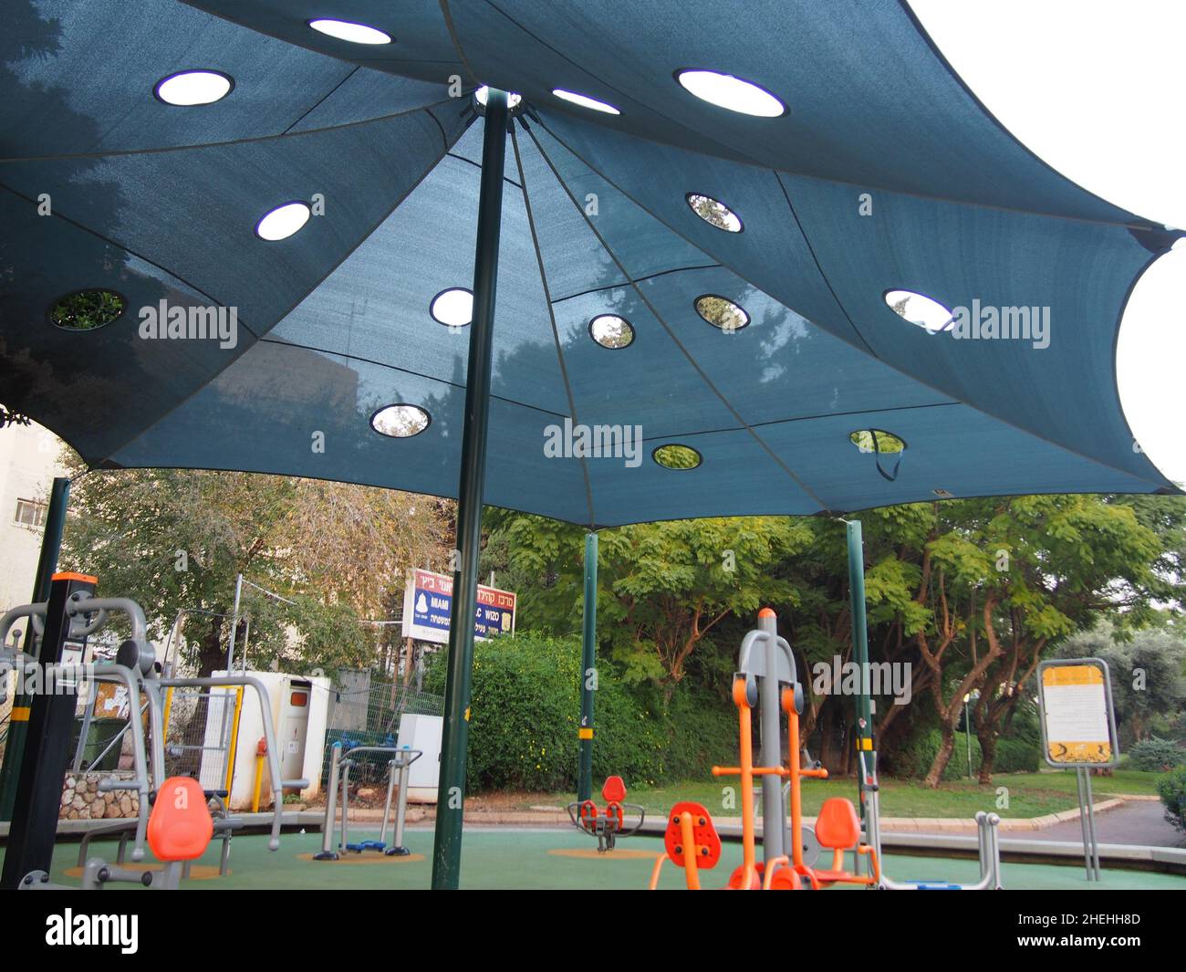 Blue roof with holes over the playground Stock Photo - Alamy
