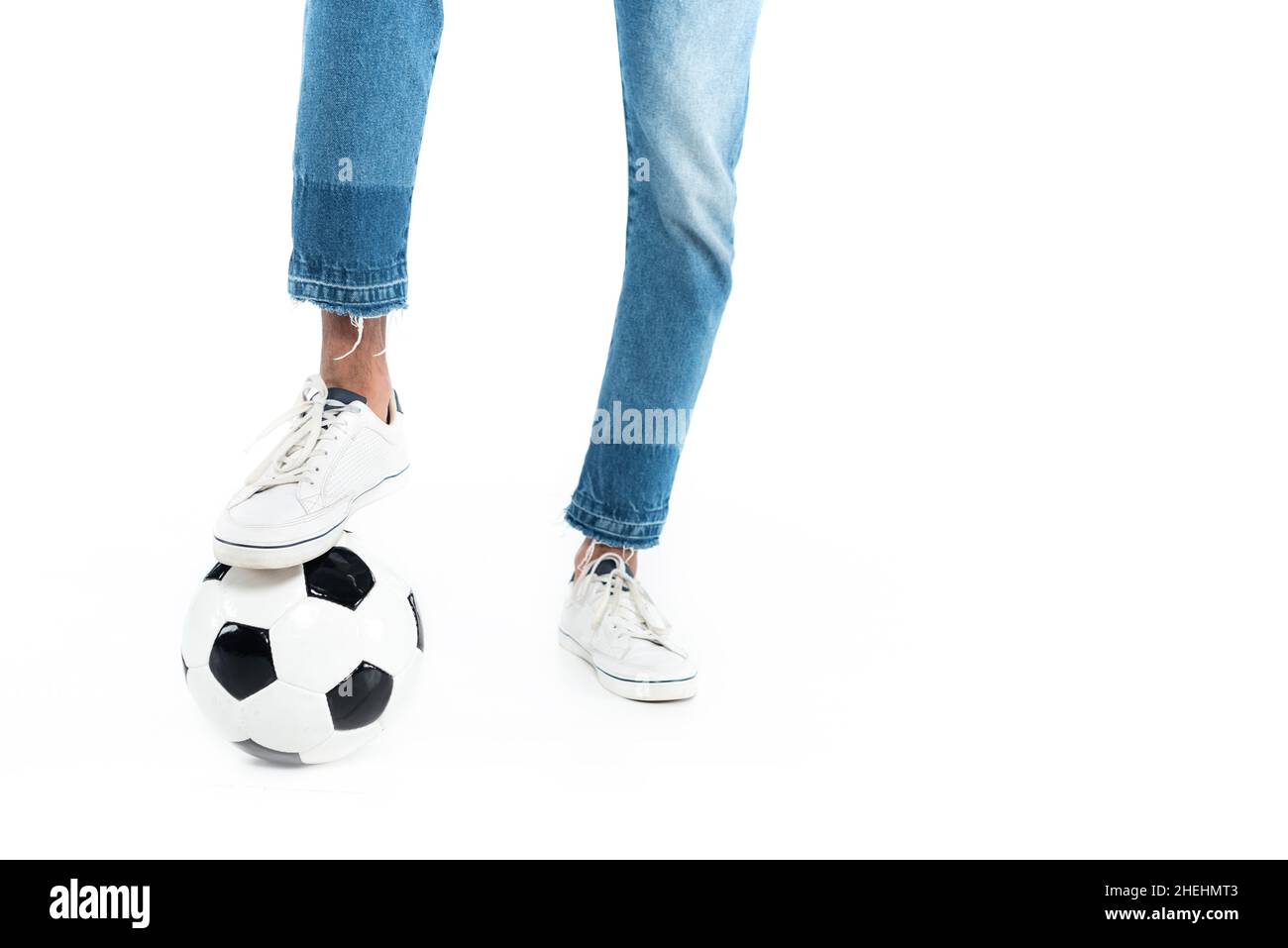 partial view of african american man in sneakers and jeans playing ...