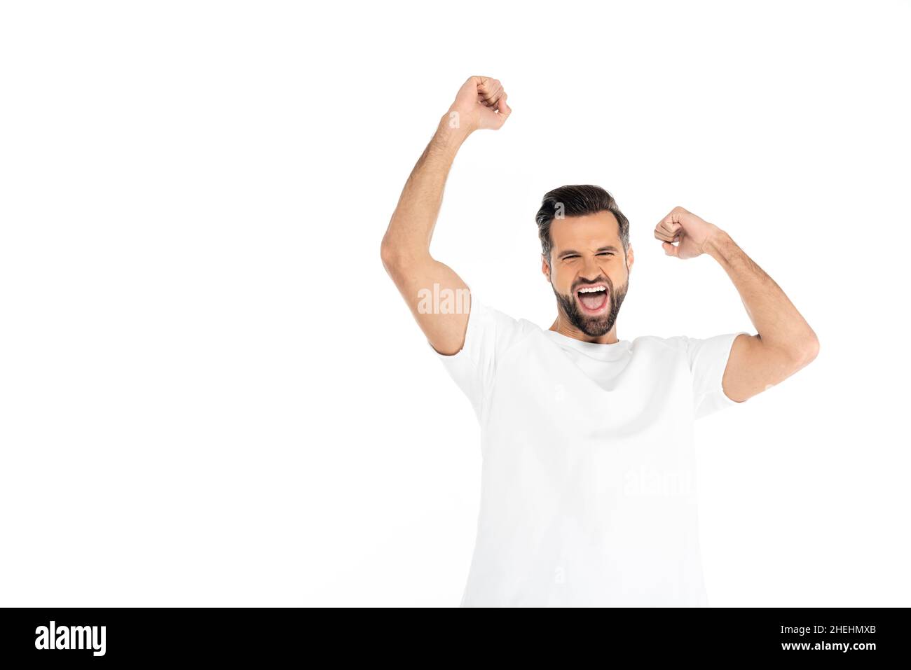 excited man screaming while showing triumph gesture isolated on white ...