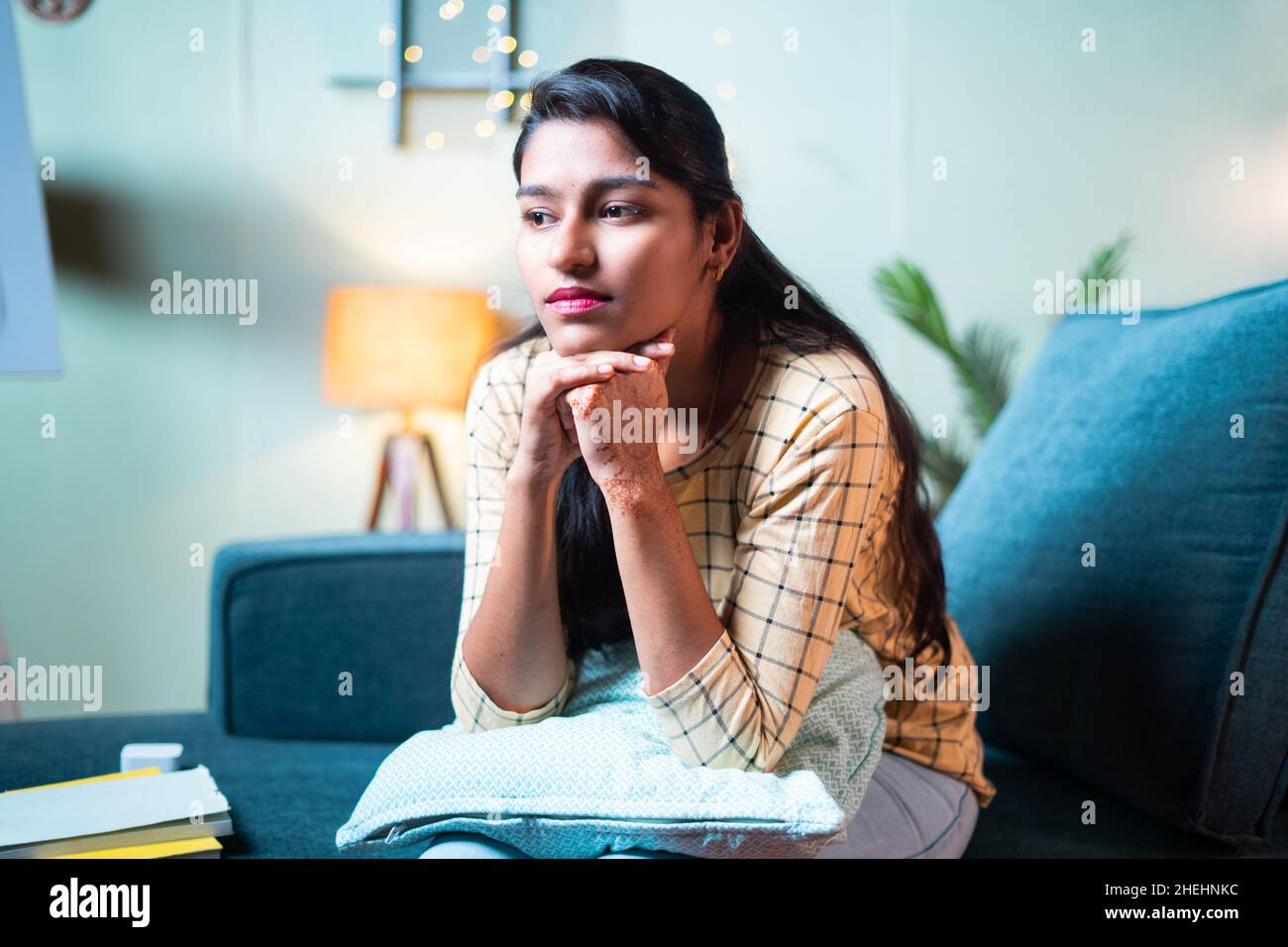 Deep thinking sad young girl at home - concept of focused, unhappy and ...