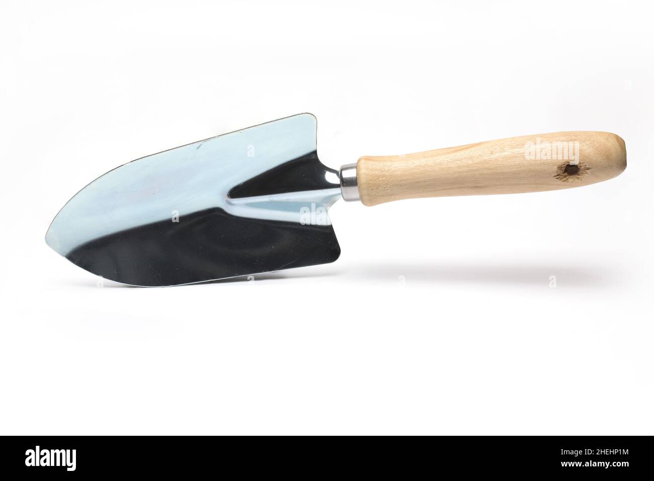 Close up of metal garden shovel hand shovel with wooden handle on white ...