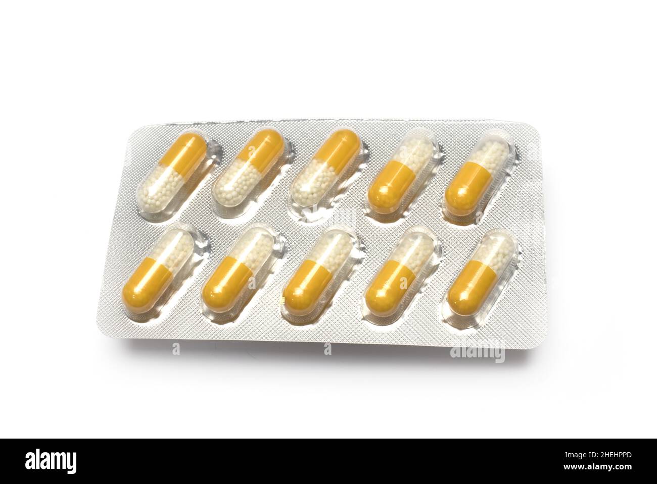 Close up of silver blister with big yellow and white pills tablets on ...