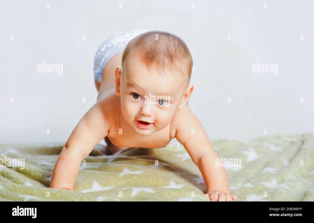 Baby in bed. Beautiful expressive adorable happy cute laughing smiling ...