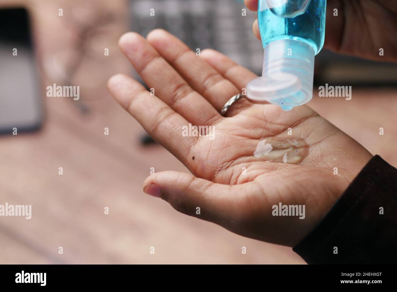 Using sanitizer liquid for preventing corona virus Stock Photo - Alamy
