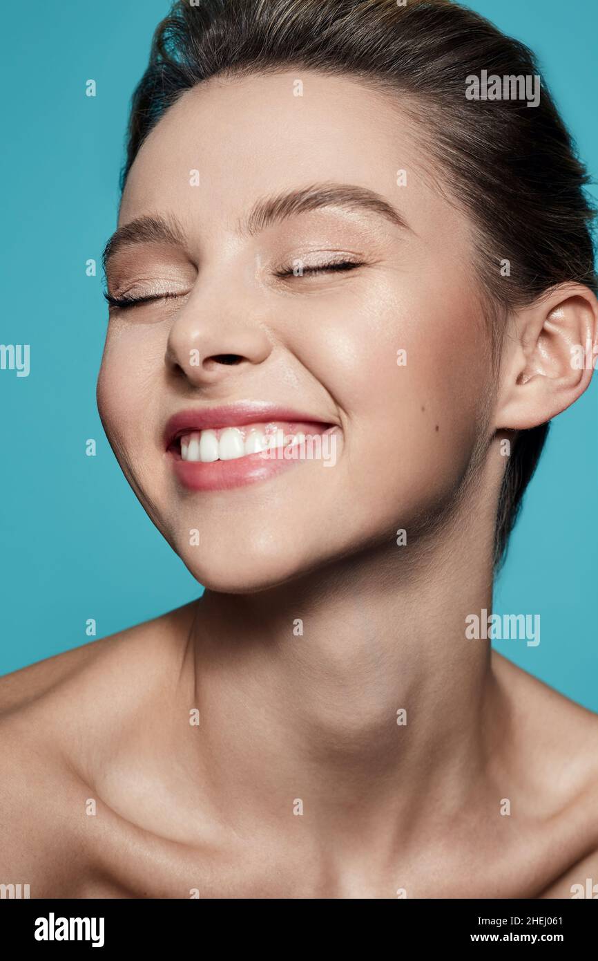 Portrait of happy caucasian young woman with healthy moisturized facial ...
