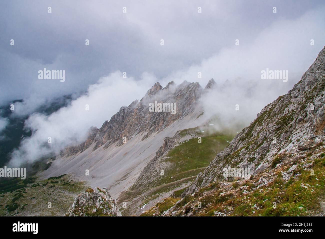 Alpine mountain range on a cloudy day in late summer Stock Photo - Alamy