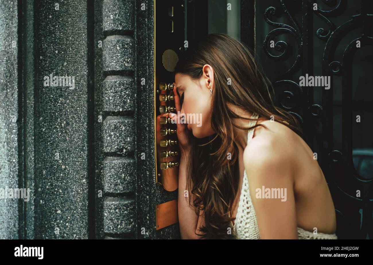 Lady woman intercom doorbell at building entrance. Young dress female ...