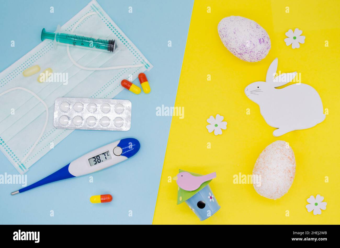 Colorful eggs, decorations, flowers and an Easter Bunny on a yellow ...