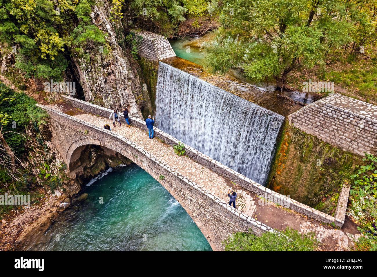 The old stone, arched bridge, between two waterfalls in Palaiokaria ...