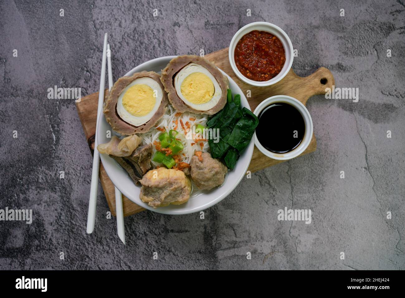 Indonesian street food Bakso or meat ball with egg inside. serving with ...