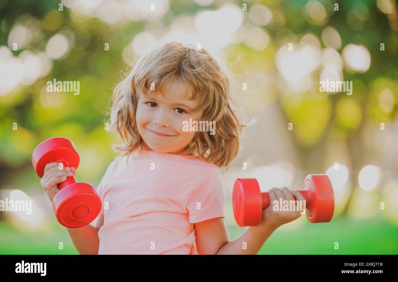 Kid workout. Child exercising with dumbbells. Sporty child with ...