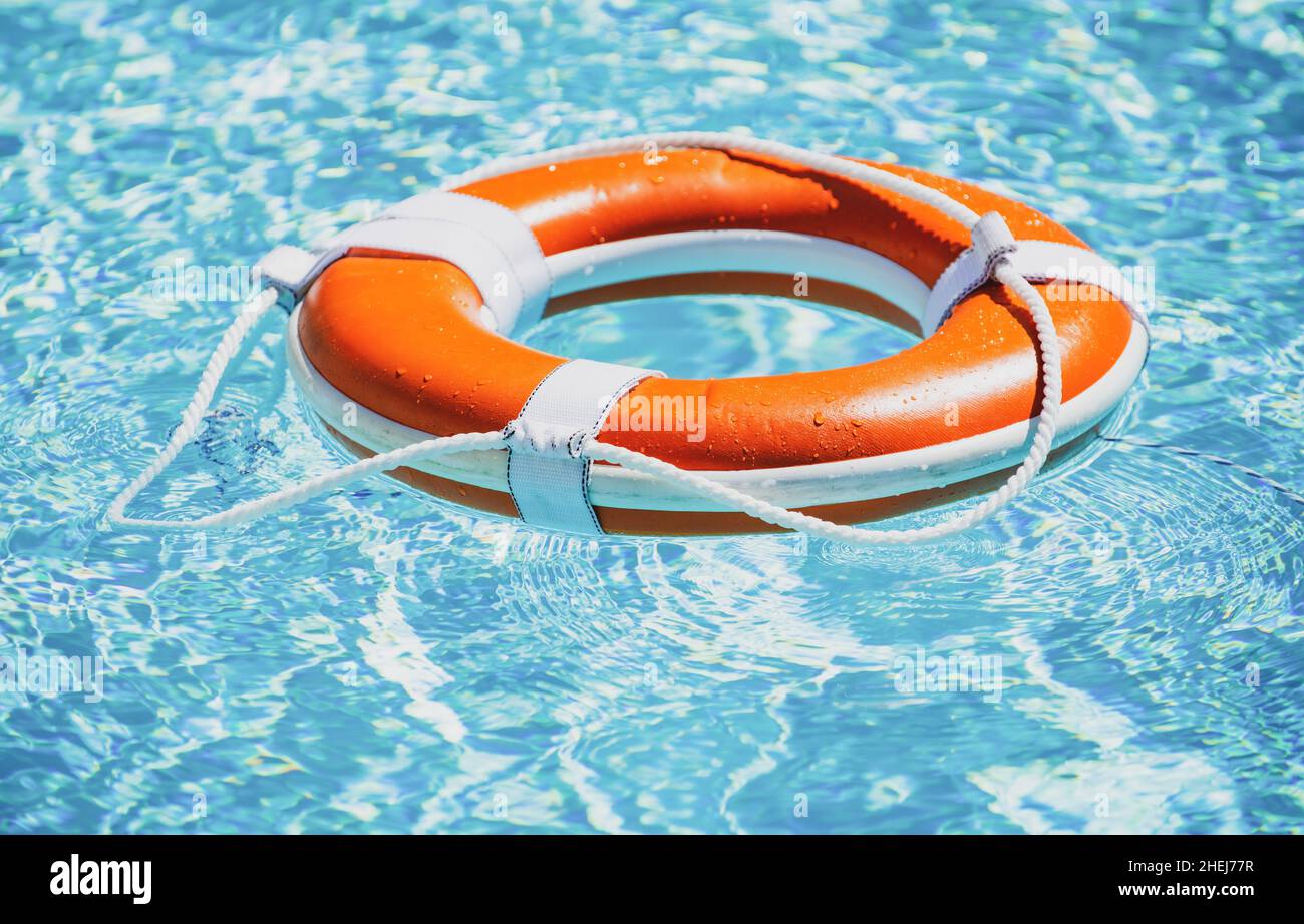 Lifebuoy pool ring float on blue water Stock Photo - Alamy