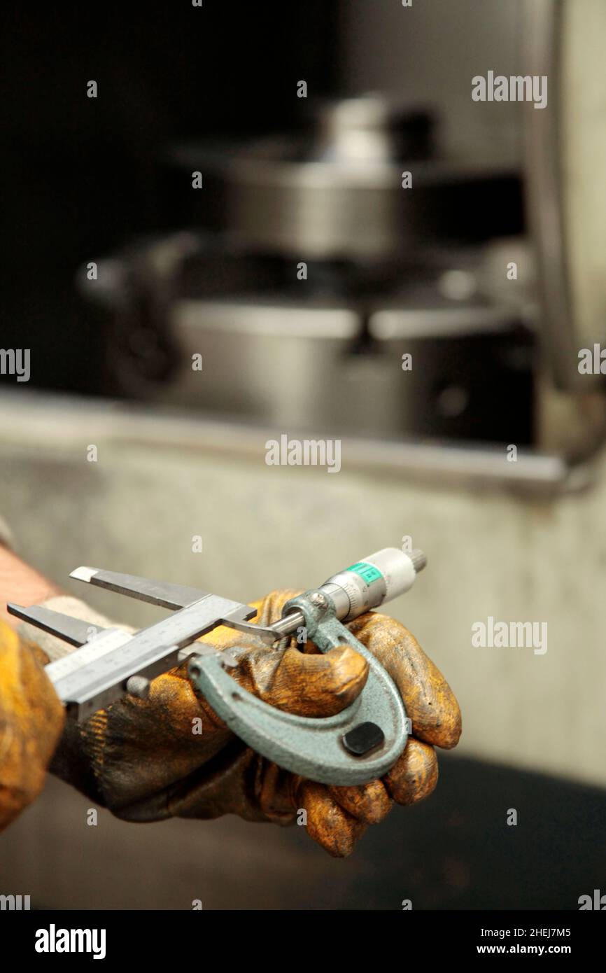 Metal measuring instruments in worker's hand. Vernier caliper ...