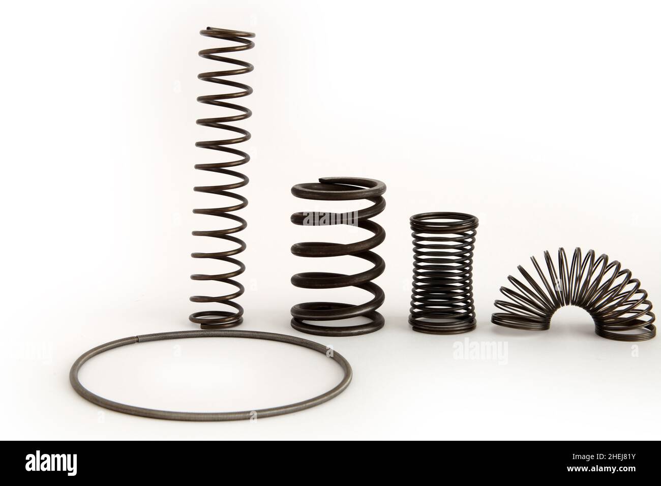 assorted steel spring kits on a white background Stock Photo - Alamy