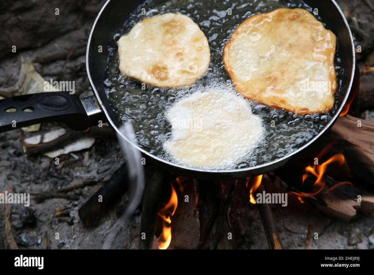 frying dough in wood fire Stock Photo - Alamy