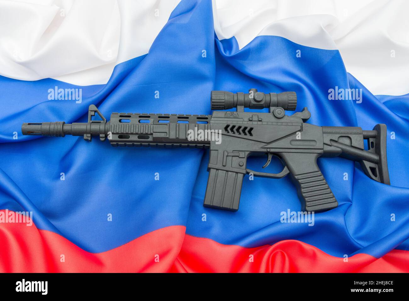 Russian Federation flag with black toy assault rifle. For Russian ...