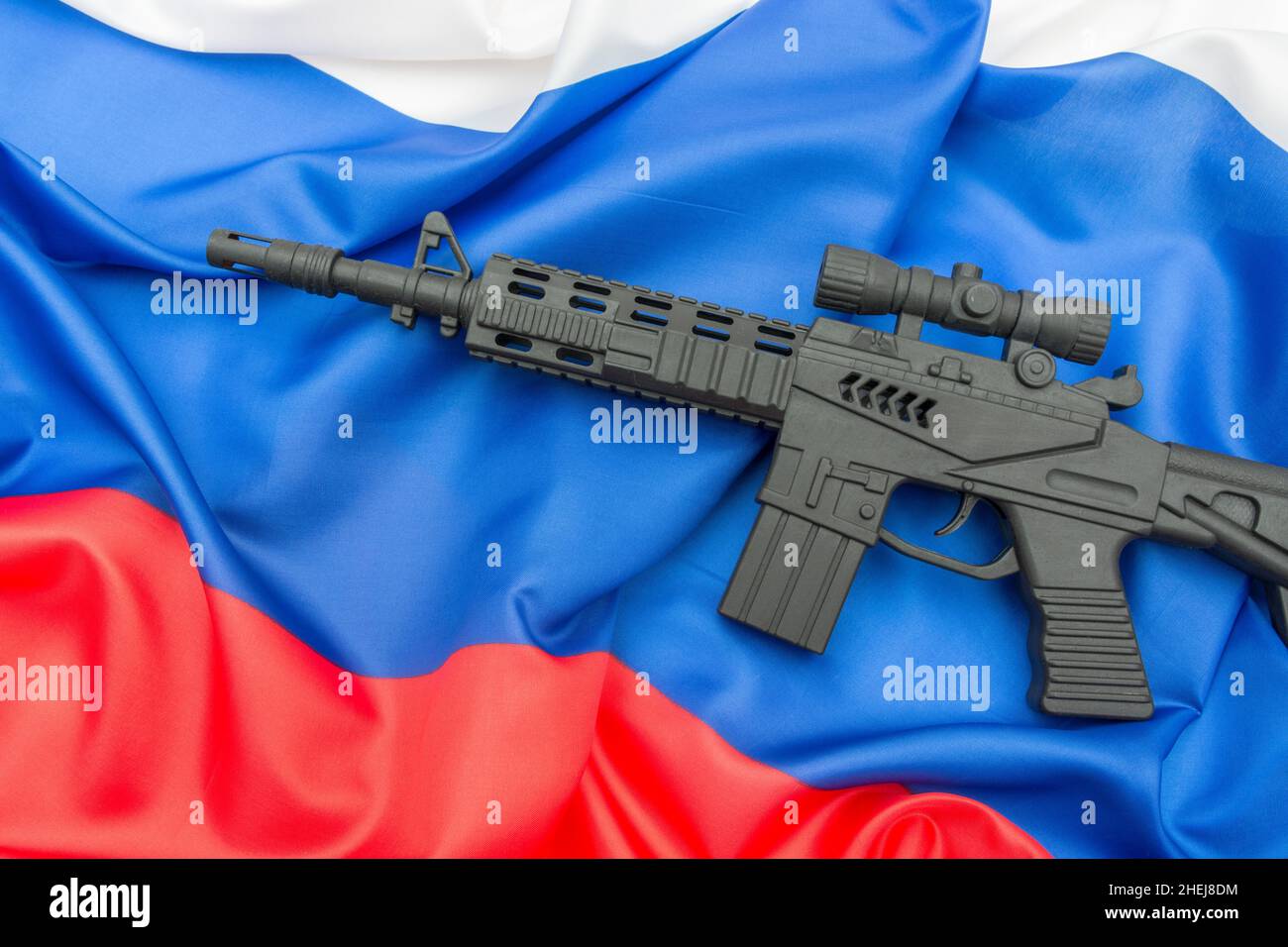 Russian Federation flag with black toy assault rifle. For Russian ...