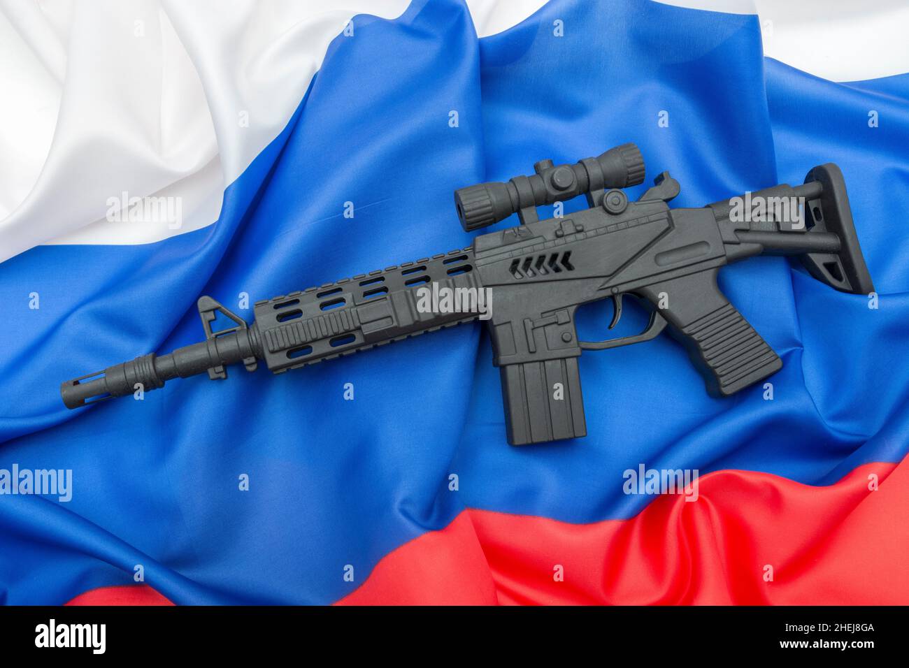 Russian Federation flag with black toy assault rifle. For Russian ...