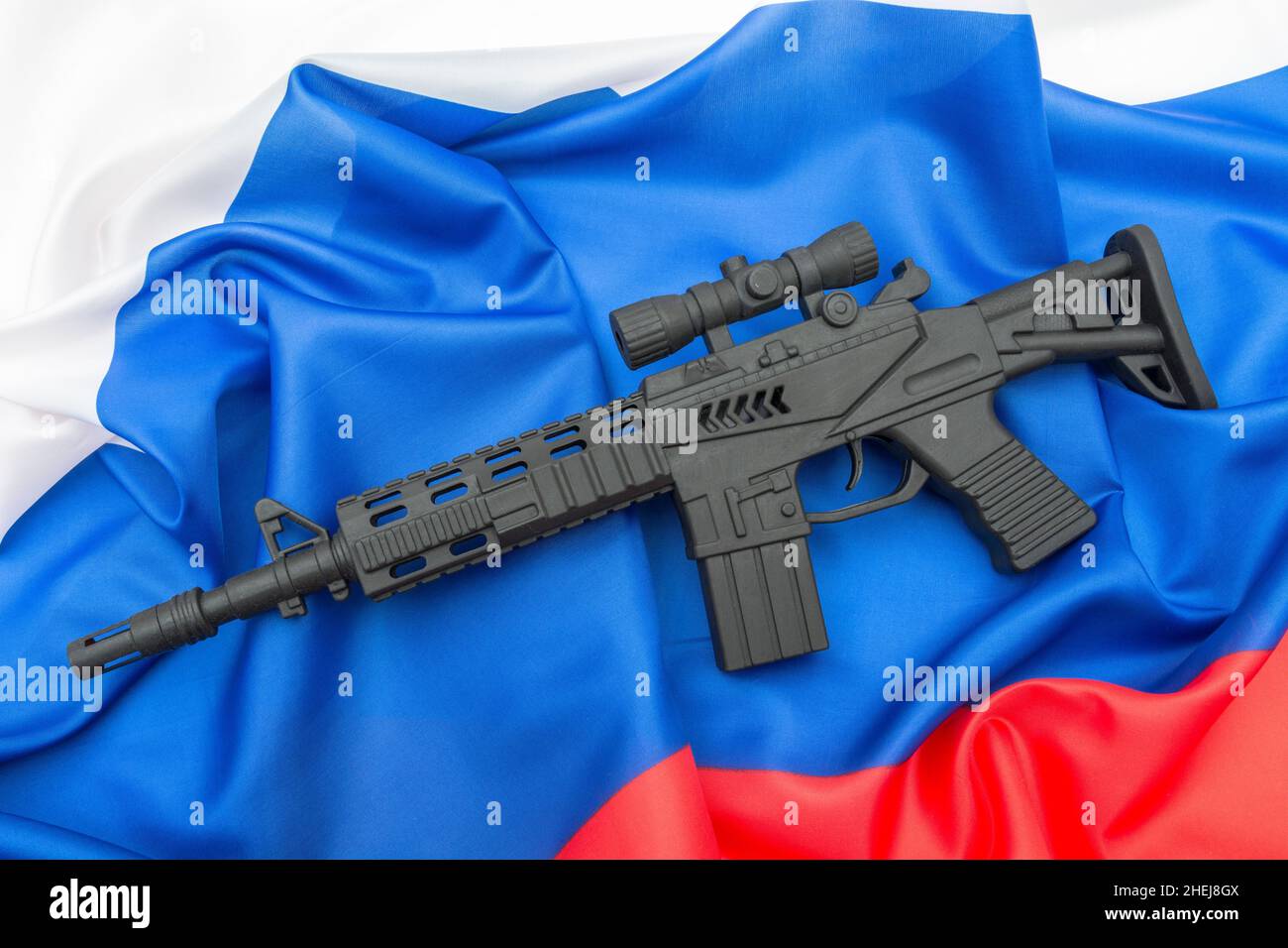Russian Federation flag with black toy assault rifle. For Russian ...