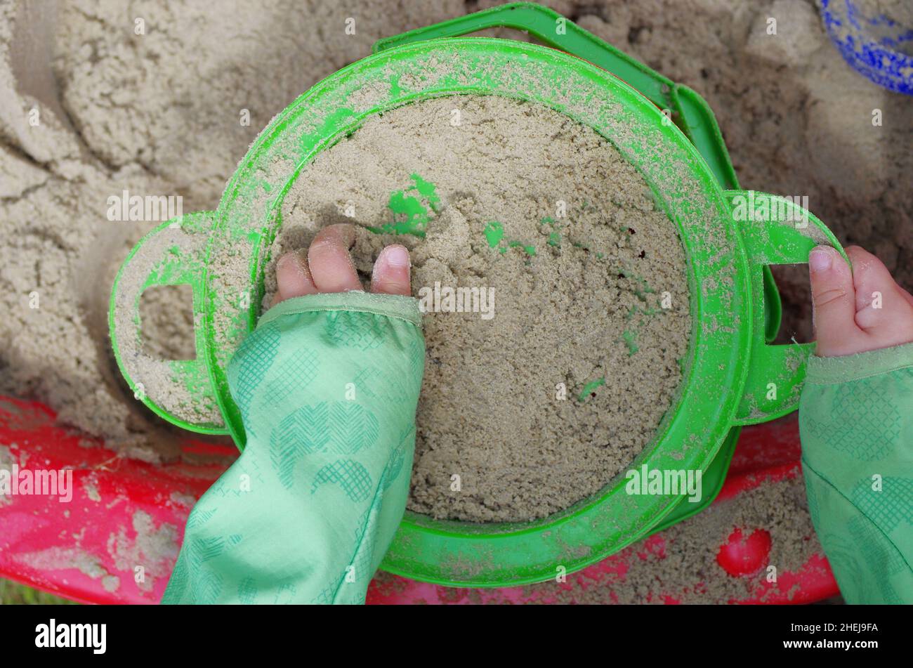 child playing sand sieve sieving Stock Photo - Alamy